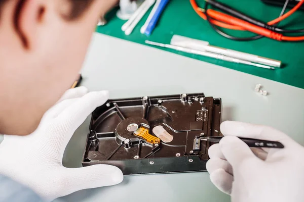 man repairing hard drive in service center. Repairing and fixing ...