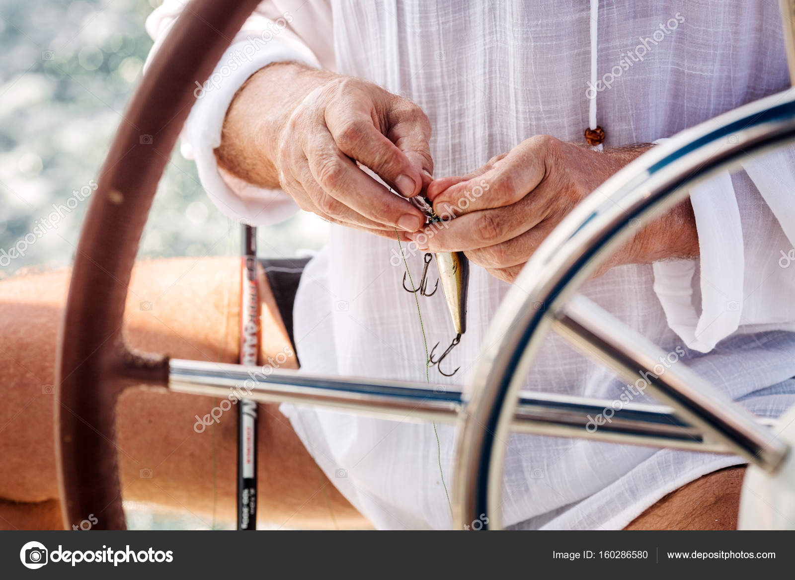 Man hands tying a triple hook for fishing and holding the bait — Stock ...