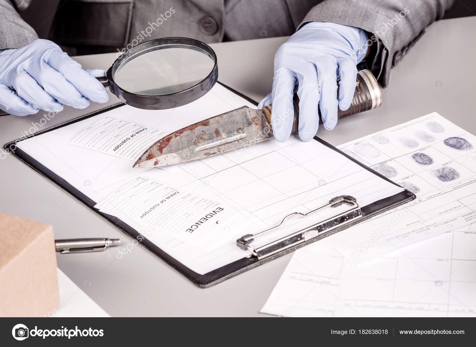 Detective through a magnifying glass looking at a evidence Stock Photo ...
