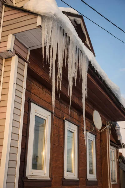 Icy icicles on roof of houses in Russian winter Stock Photo by ...