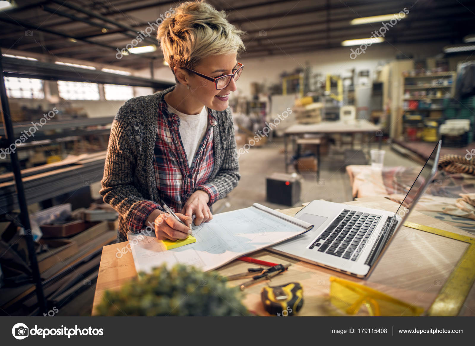 Hardworking Professional Female Engineer Working Laptop Blueprint ... Hardworking Professional Female Engineer Working Laptop Blueprint ...