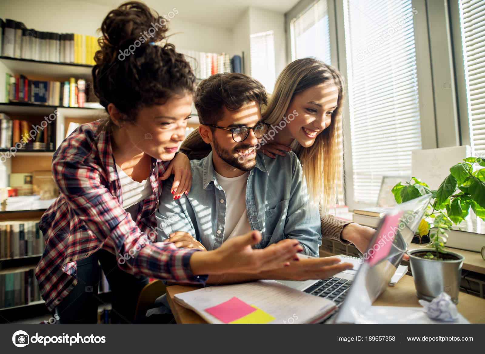 Three Young Hardworking Students Studying Library Using Laptop Stock ...
