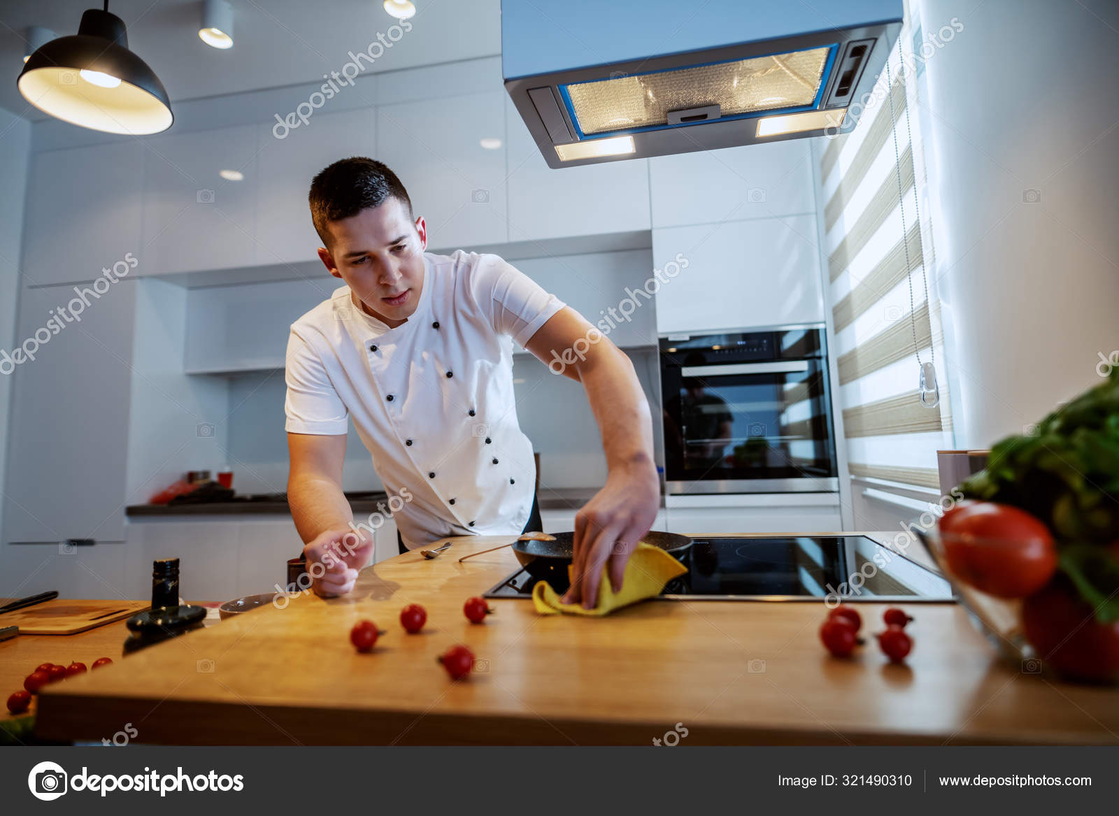 Attractive Serious Caucasian Chef Uniform Cleaning Stove While Cooking ...