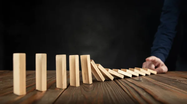 Businessman Letting Or Preventing Dominoes Chain Toppling — Stock Photo ...