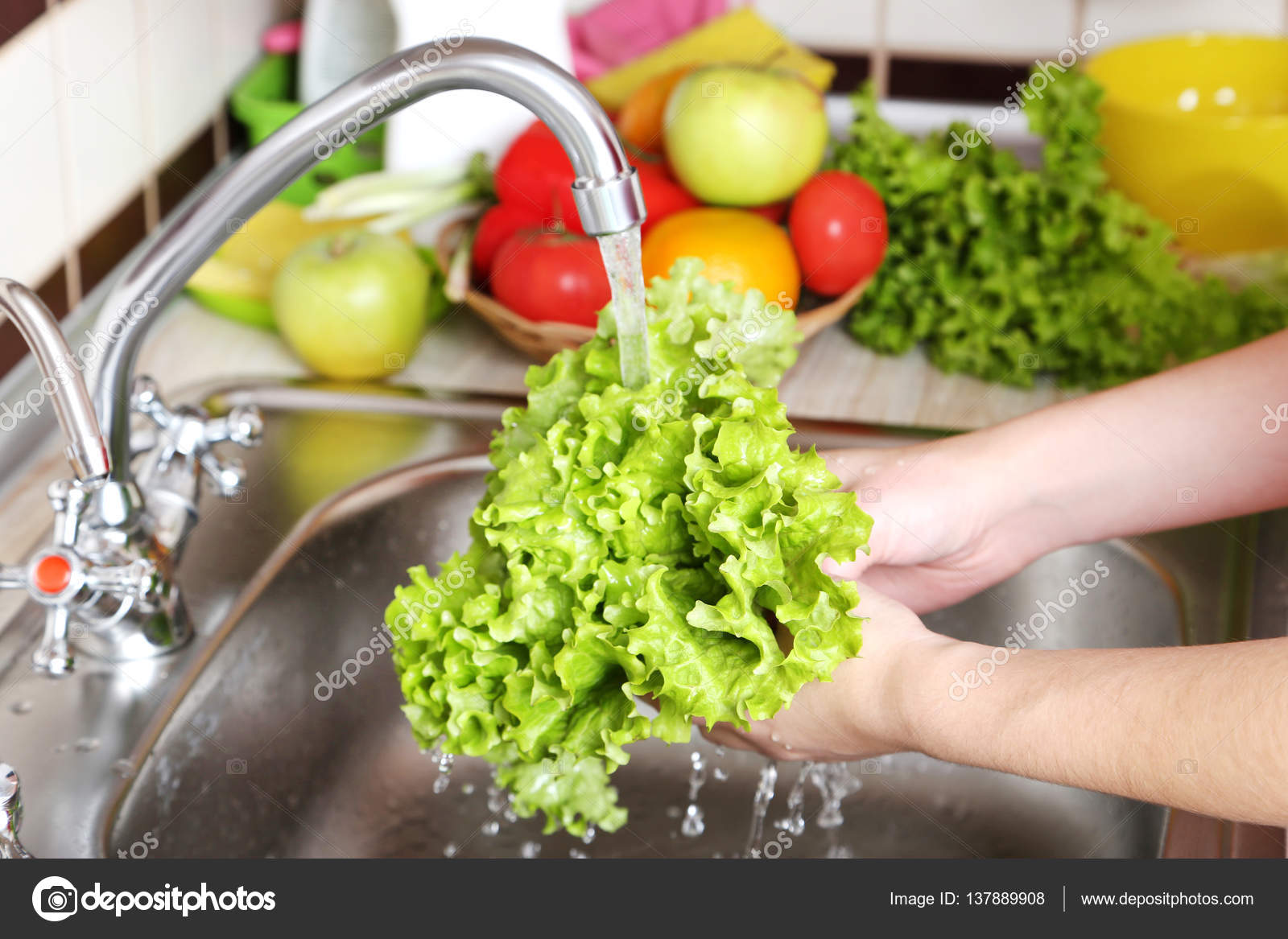 Vegetables washing in kitchen Stock Photo by ©5seconds 137889908
