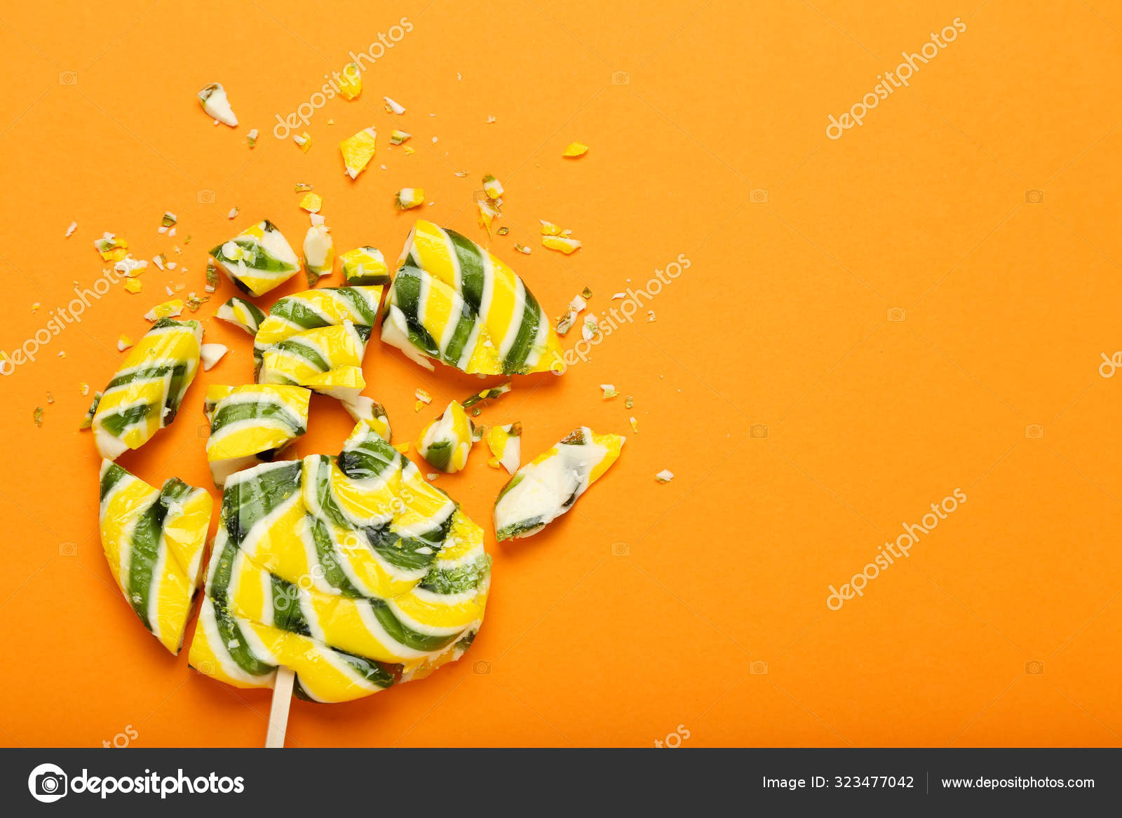 Broken Lollipop Candy Orange Background Stock Photo by ©5seconds 323477042