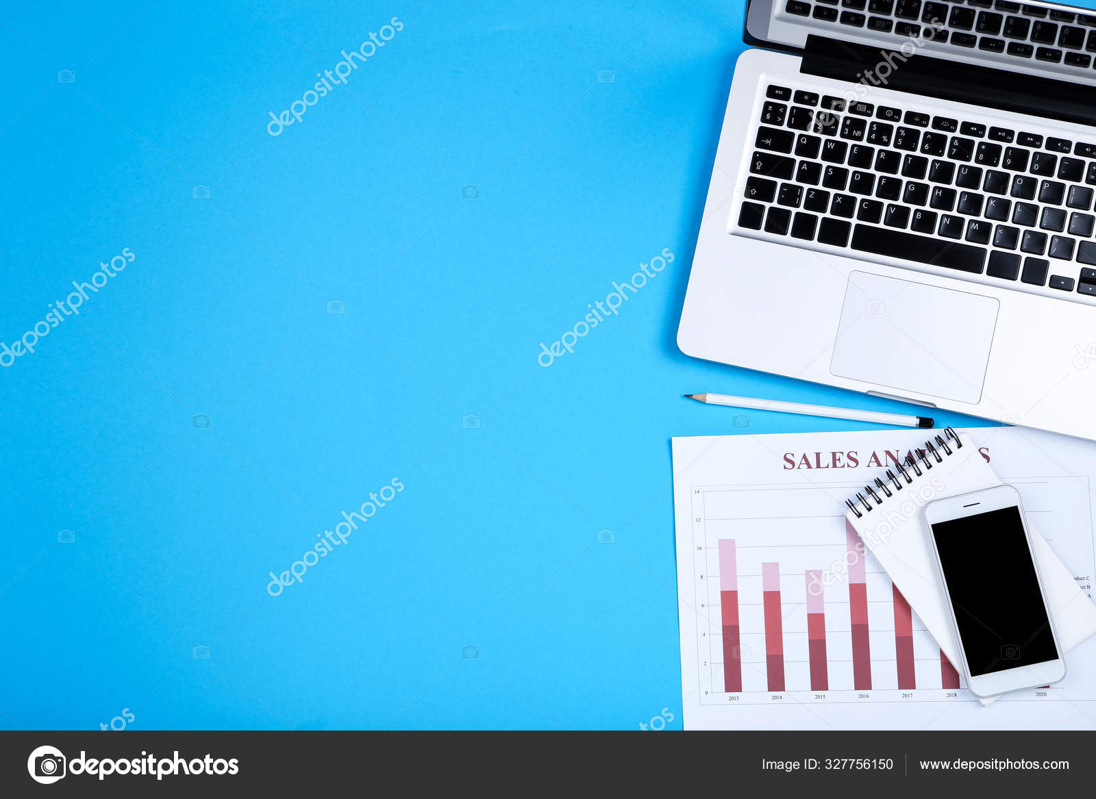 Laptop computer with paper charts, notepad and smartphone on blu Stock ...