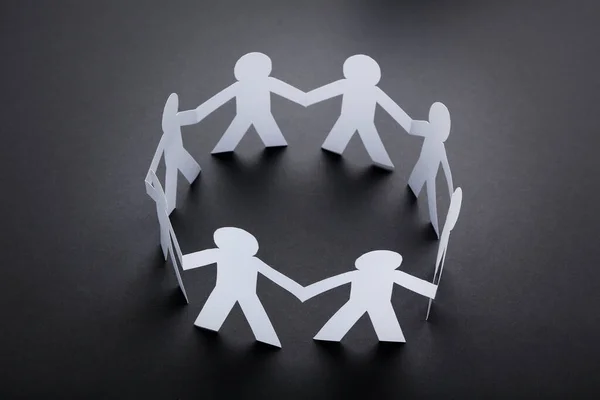 Paper chain people with female hands on white background — Stock Photo ...