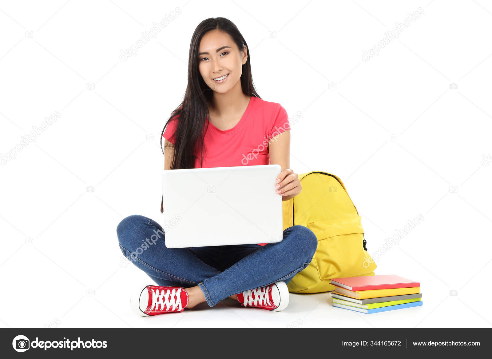 Young woman with laptop computer, books and backpack on white ba ...
