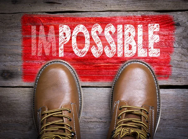 Impossible - Possible. Top View of Boot on wooden background - Stock ...