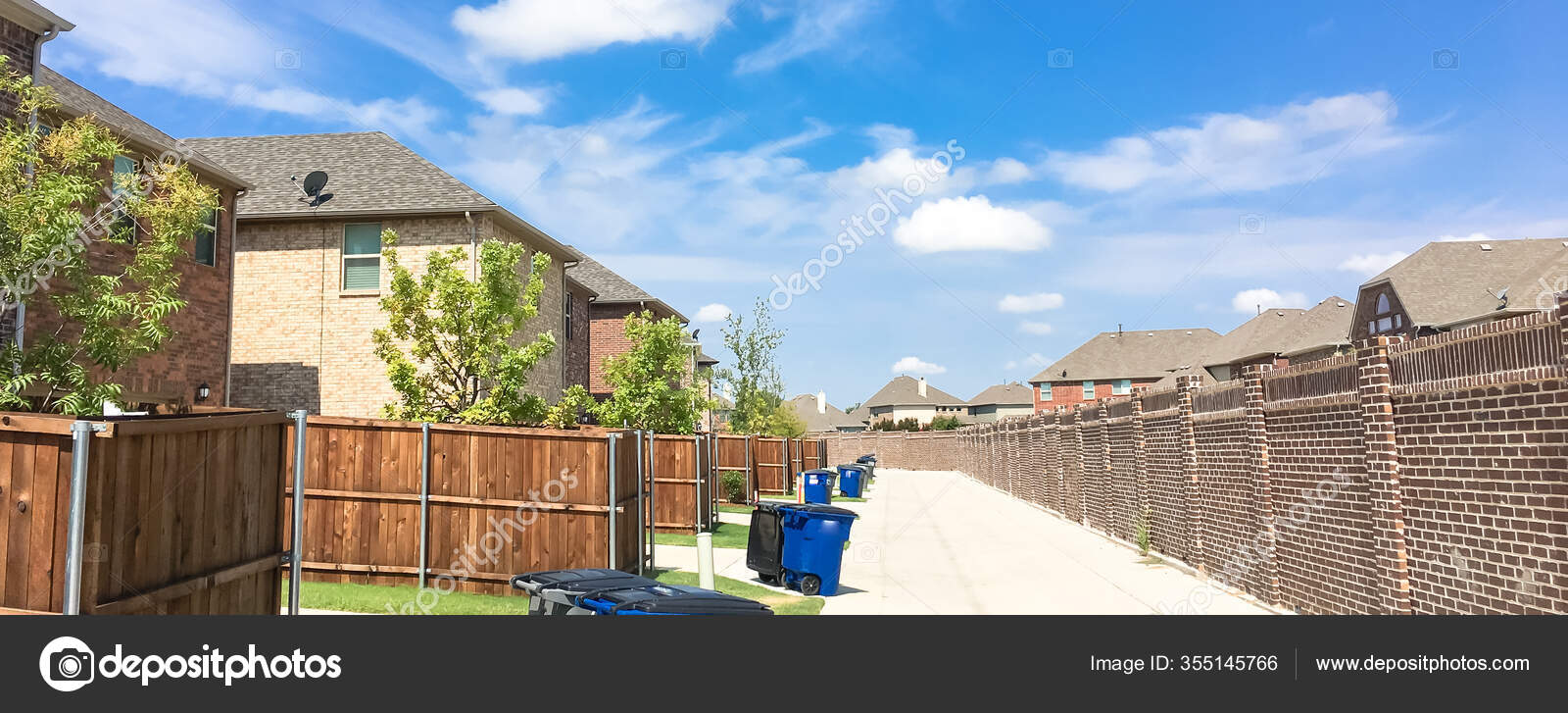 Panoramic concrete back alley with trash containers of new residential ...