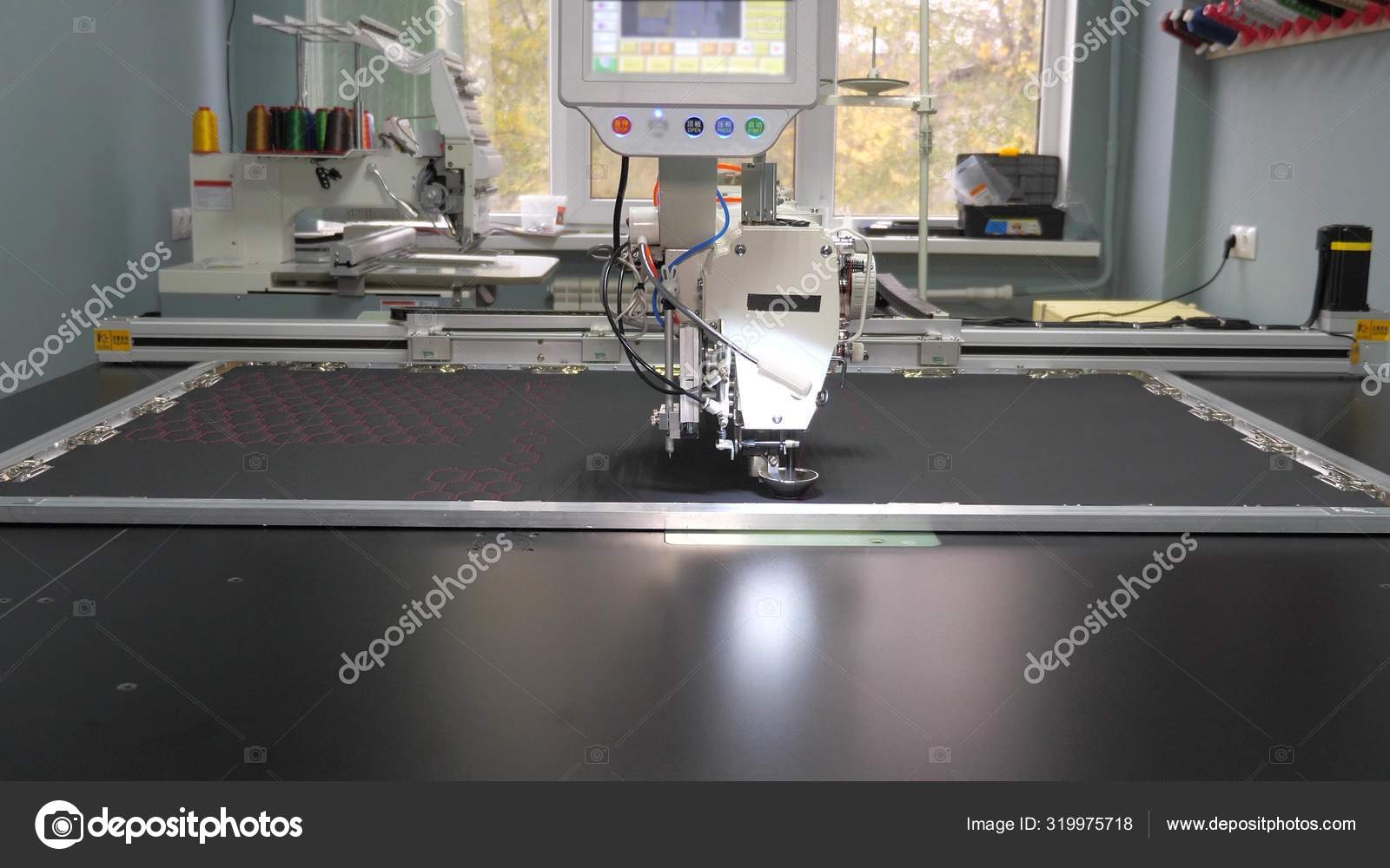 Robotics with cnc works in sewing production line. Robot sewing machine ...