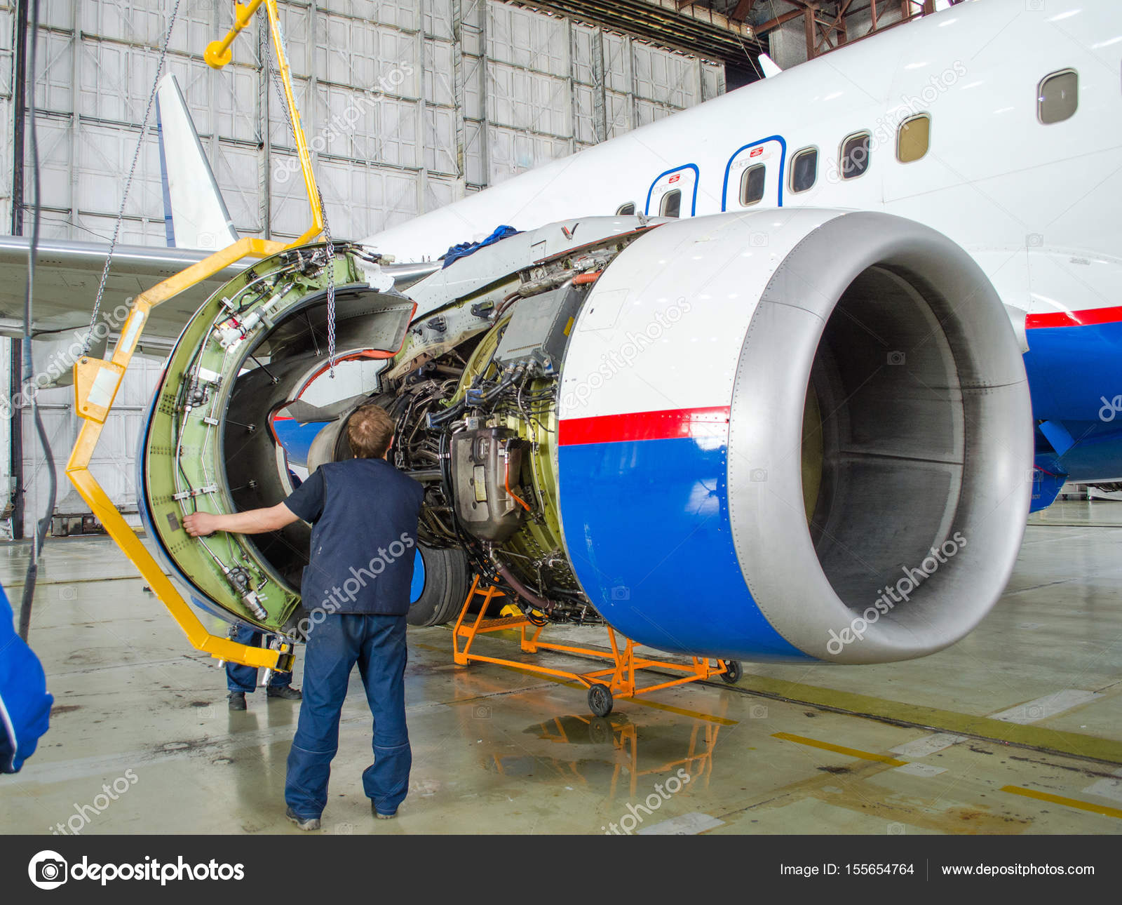 Replacing the engine on the plane, working people tap. Concept ...