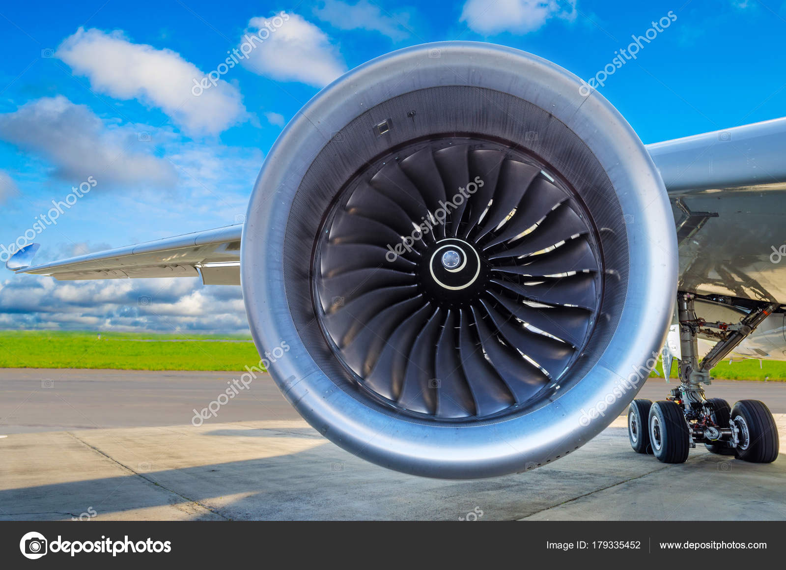 Engine of the modern aircraft close up and the blue clouds in the sky ...