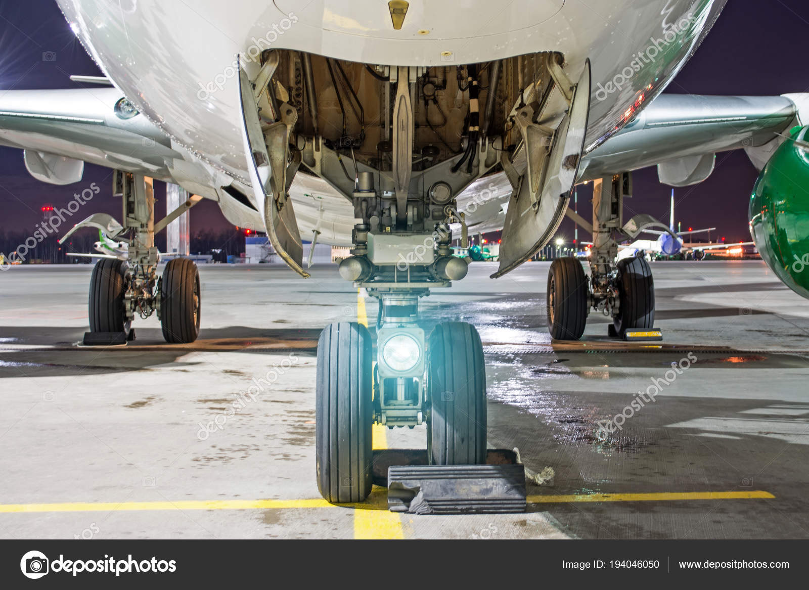 Three racks of the airplane landing gear at night in the parking lot at ...