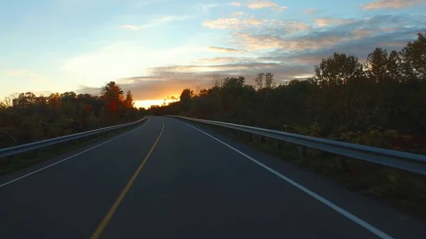 Driving a Car in Point of View Perspective on a Road at Sunset ...