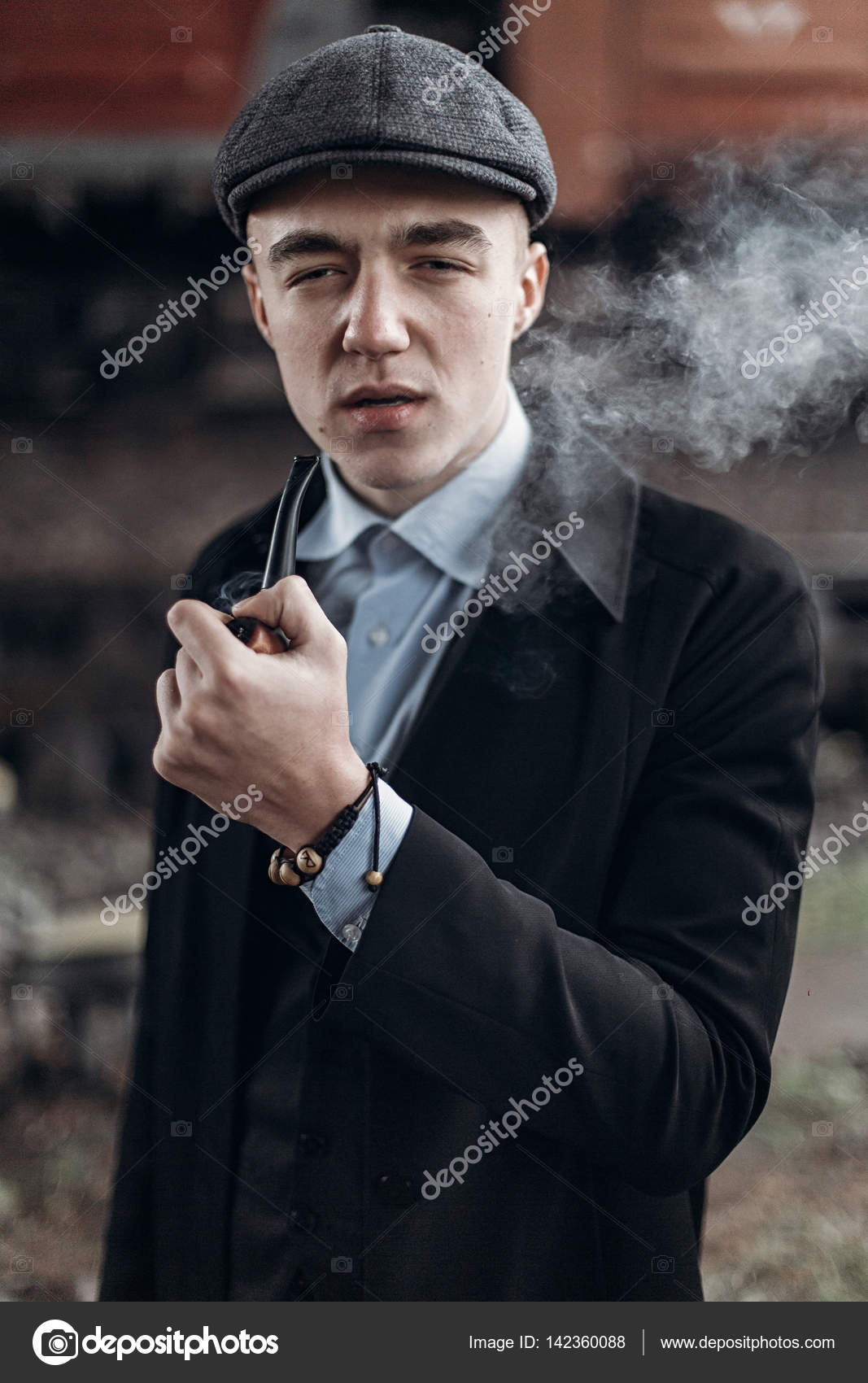Stylish gangster man smoking Stock Photo by ©Sonyachny 142360088