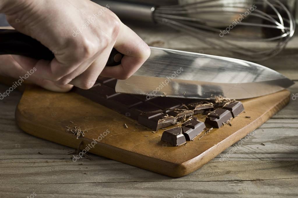 Cutting a Bar of Chocolate with a Kitchen Knife Stock Photo by ...