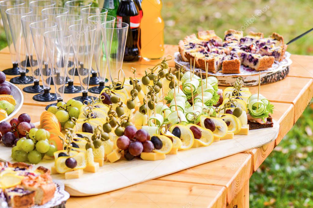 Beautifully decorated catering banquet table with different food snacks ...