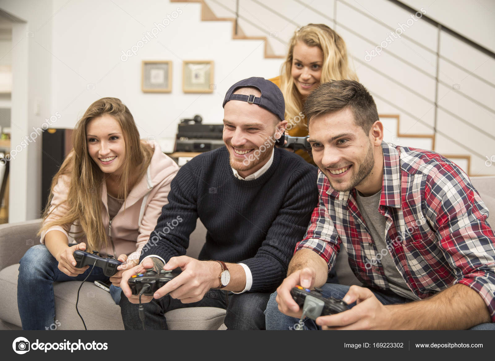 Young friends playing video games — Stock Photo © atelier211 #169223302