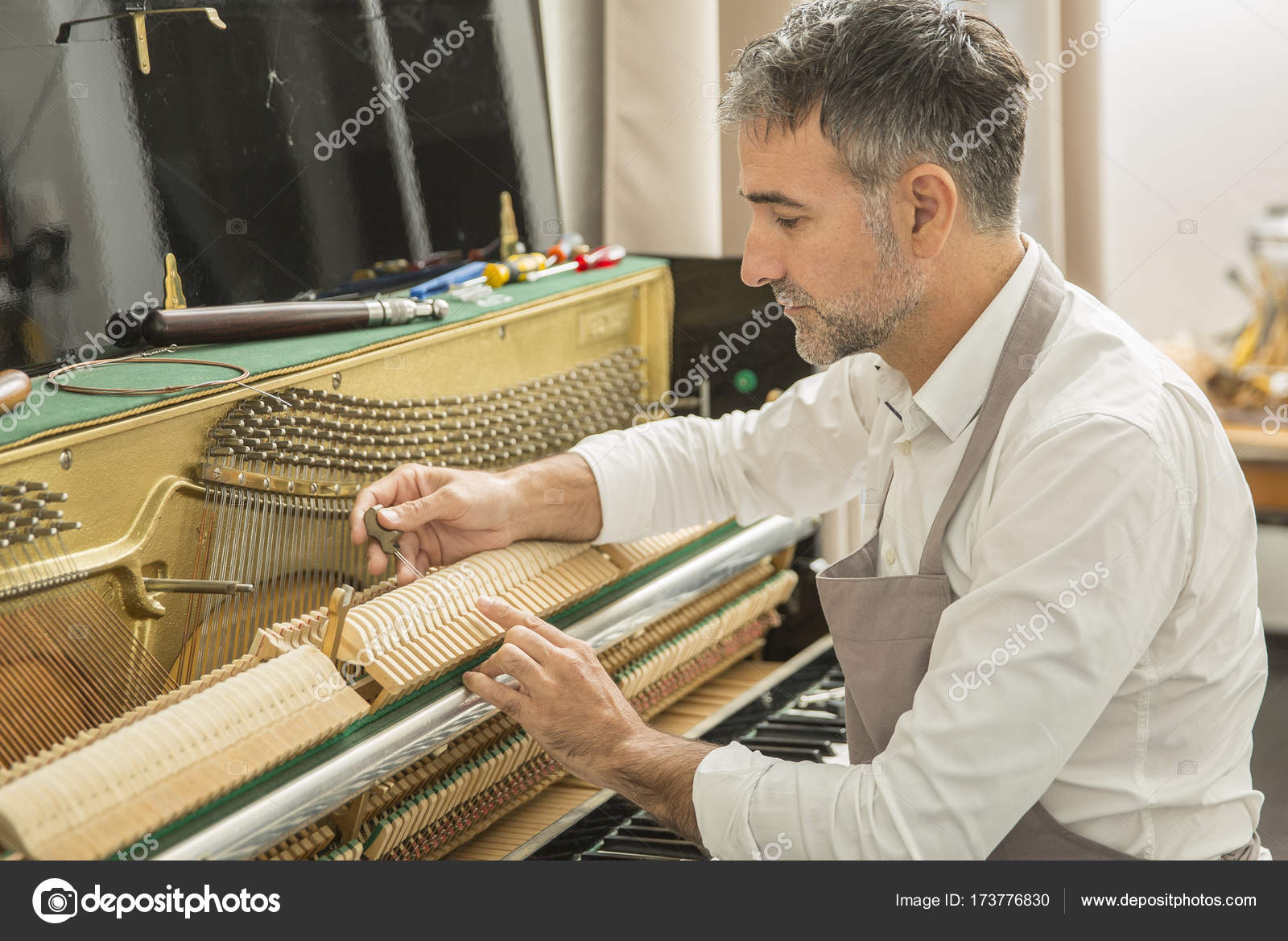 Technician tuning a upright piano using lever and tools Stock Photo by ...