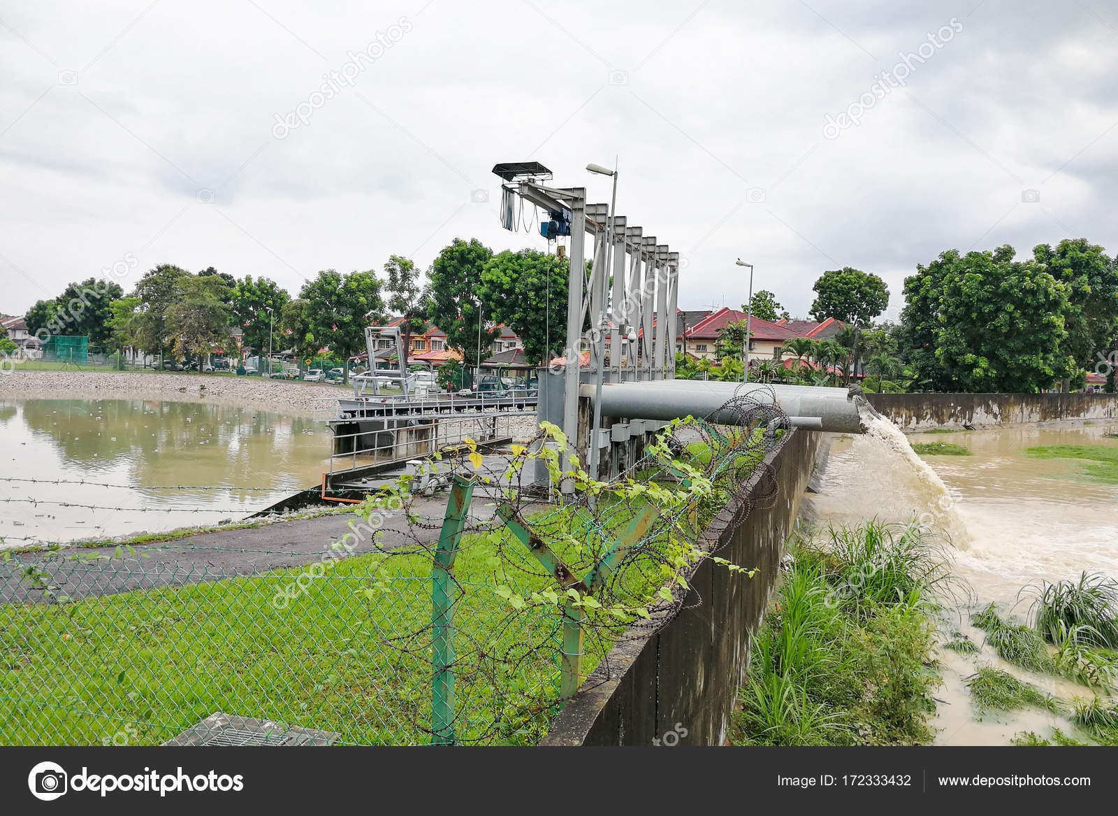 Rain water pumped into river from flood storm retention pond — Stock ...