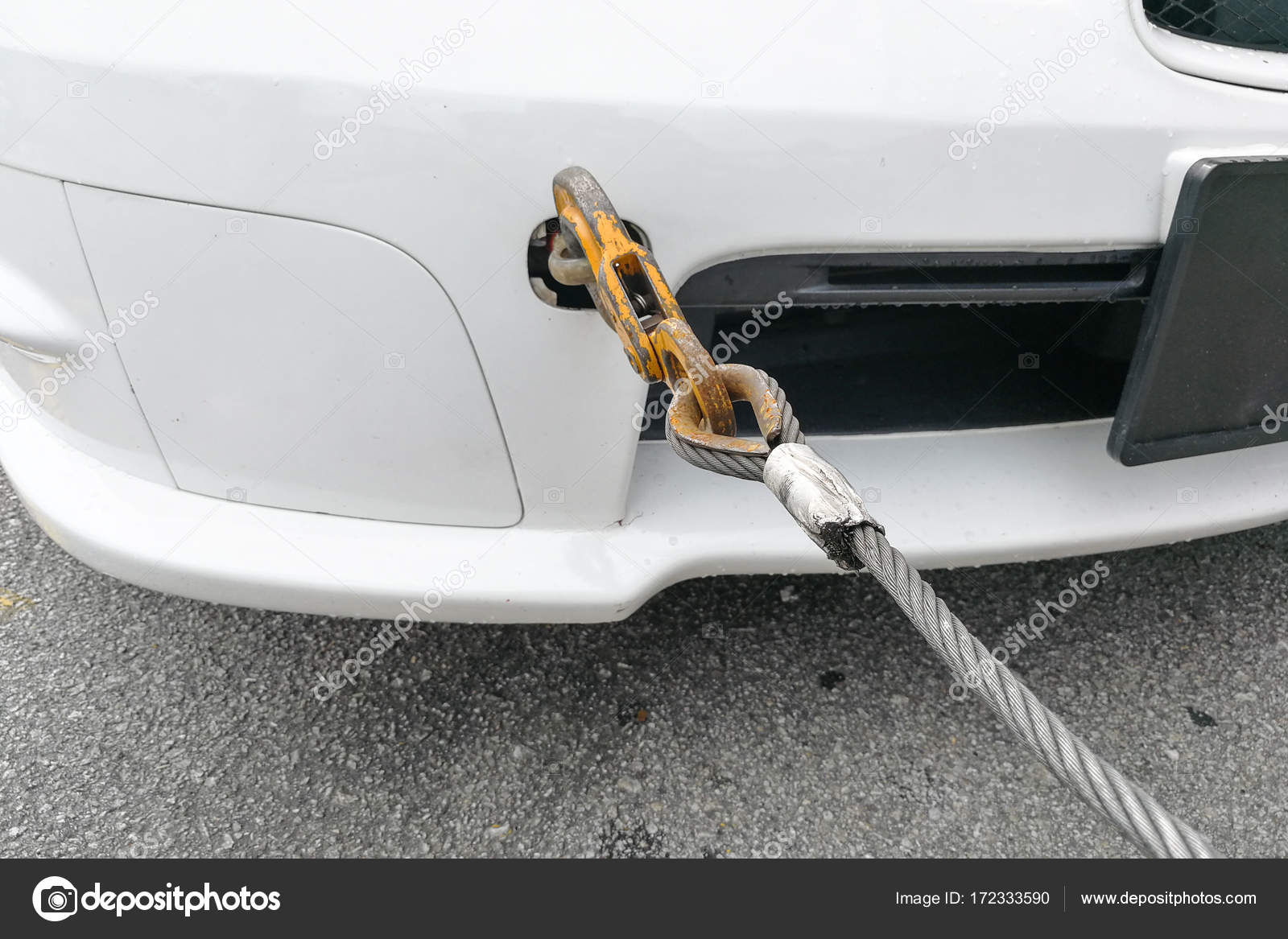 Broken down car fitted with hook and chain being towed Stock Photo by ...