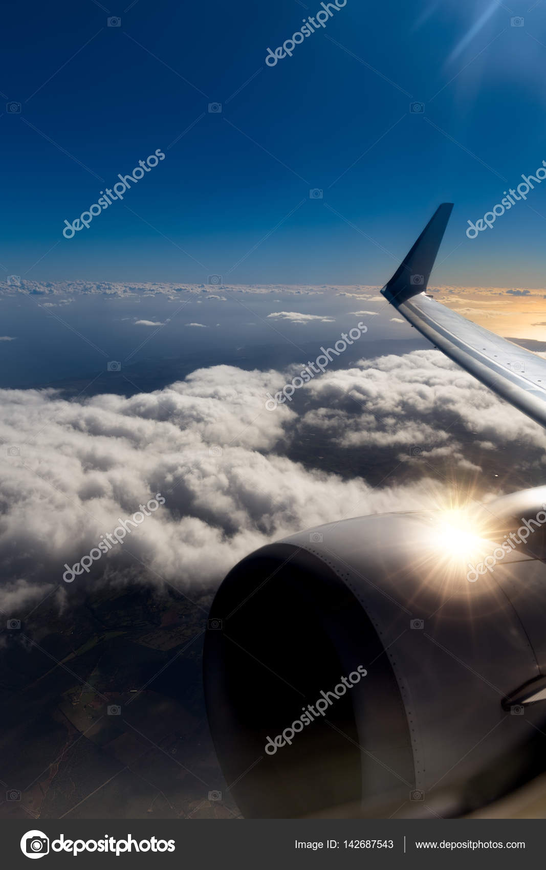 View from window of an airplane during sunset or sunrise.Wing view ...