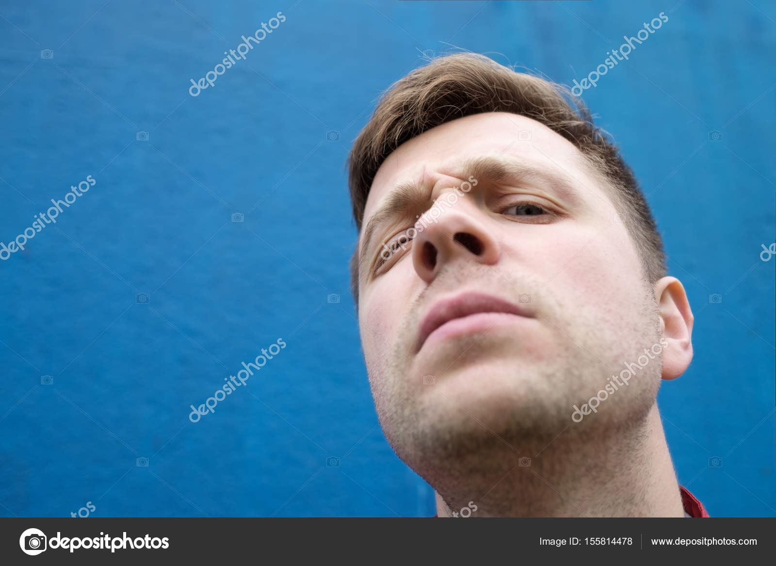 Handsome young man portrait looking down at the corner — Stock Photo ...
