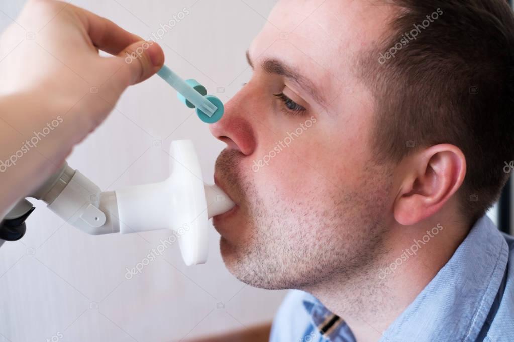 Young man testing breathing function by spirometry. — Stock Photo ...