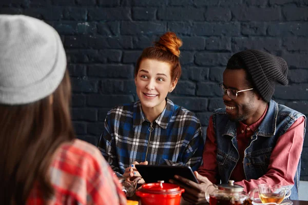 people having lively conversation at cafe - Stock Image - Everypixel