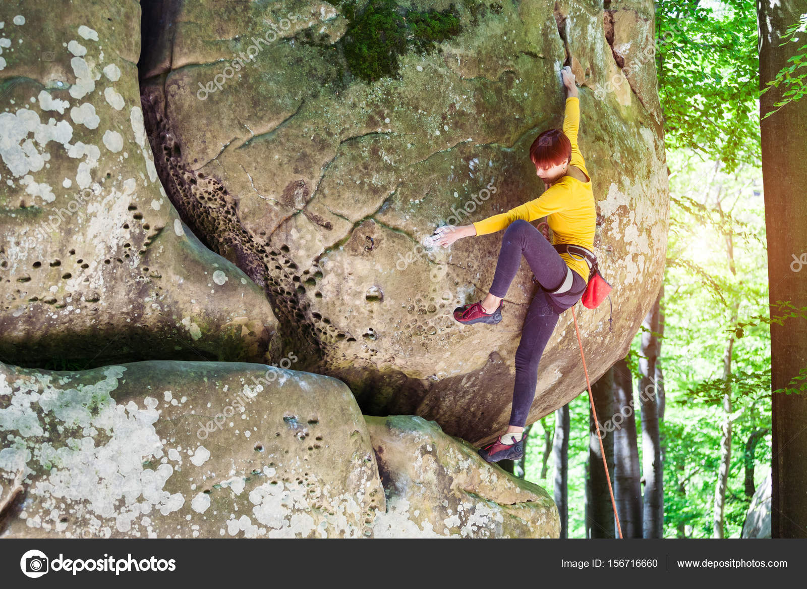 Girl is climbing the rock. — Stock Photo © zhukovvvlad #156716660