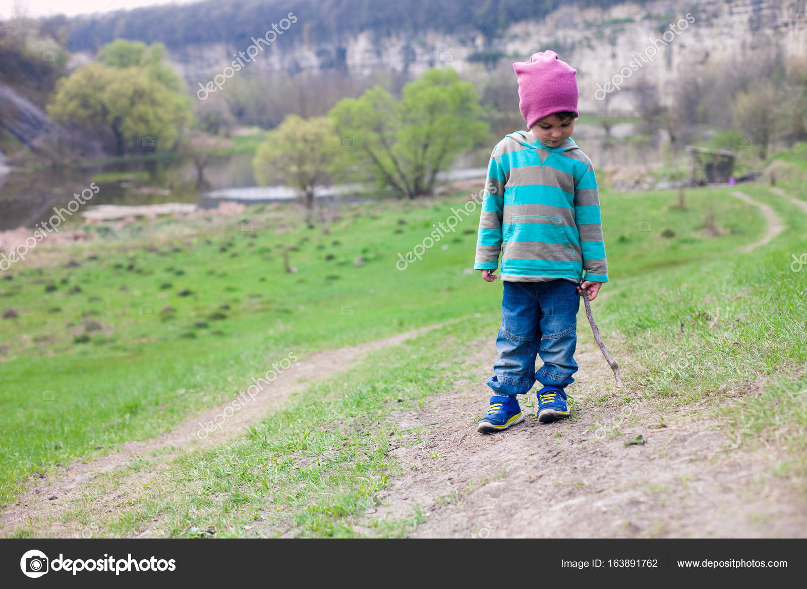 A boy with a stick. Stock Photo by ©zhukovvvlad 163891762