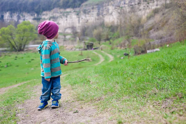 A boy with a stick. Stock Photo by ©zhukovvvlad 163891762