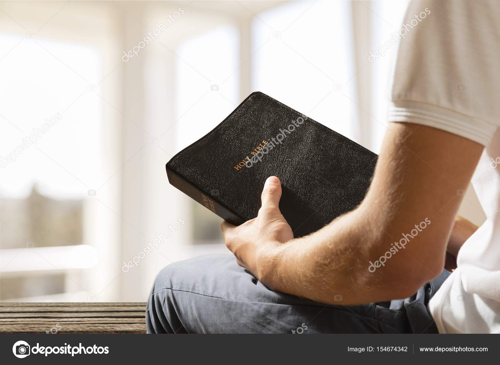 Man holding bible book Stock Photo by ©billiondigital 154674342