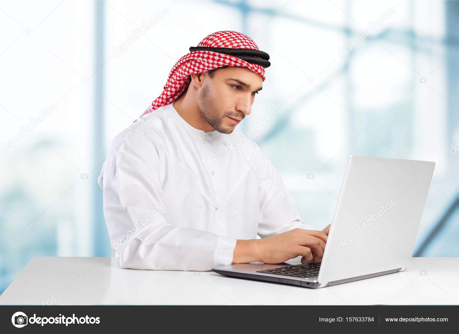 Arab man working with laptop Stock Photo by ©billiondigital 157633784