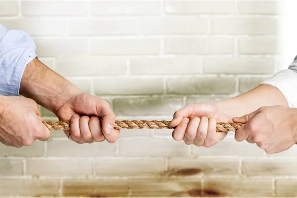businessmen pulling a rope in opposite directions - Stock Image ...