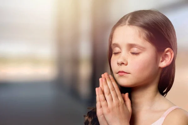 Cute Little girl praying Stock Photo by ©billiondigital 118567320