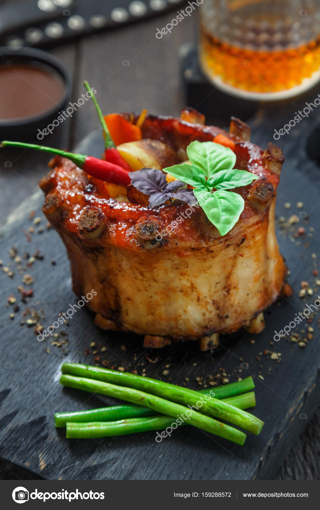 Spicy hot grilled crown ribs served on an old vintage wooden cutting ...
