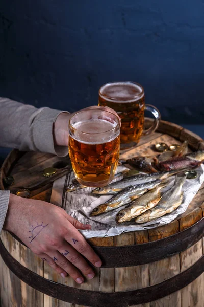 Man drink beer with dried fishes - Stock Image - Everypixel