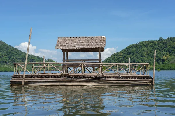 Bamboo raft floating on water with mountain background — Stock Photo ...