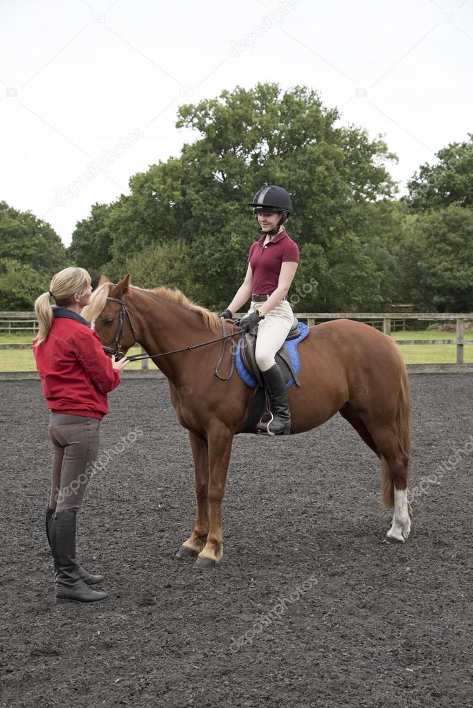 Pony and young rider under instruction from a teacher — Stock Photo ...
