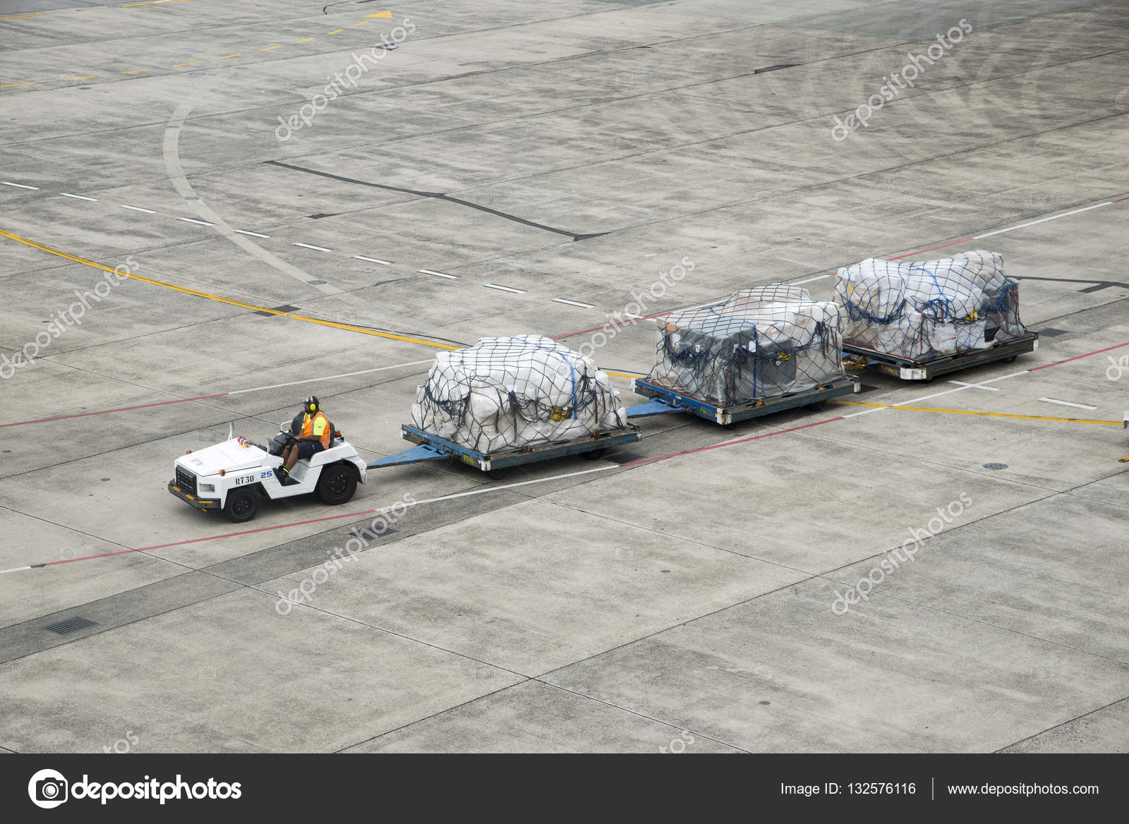 Baggage handling truck on an airport apron – Stock Editorial Photo ...