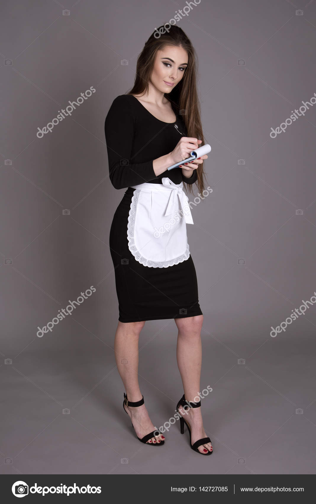 Young waitron writing a customer's food order — Stock Photo © petertt ...
