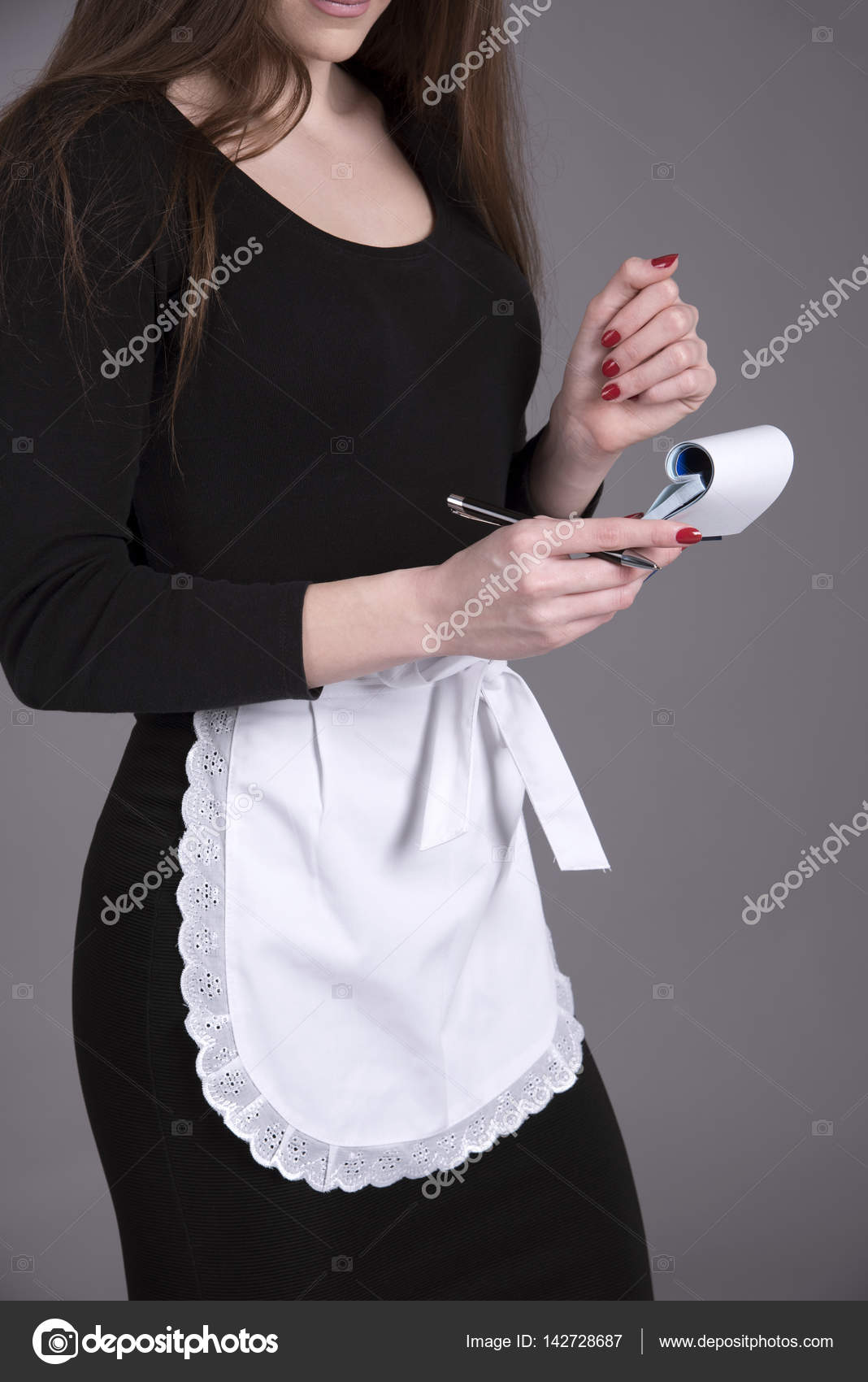 Young waitron writing a customer's food order — Stock Photo © petertt ...
