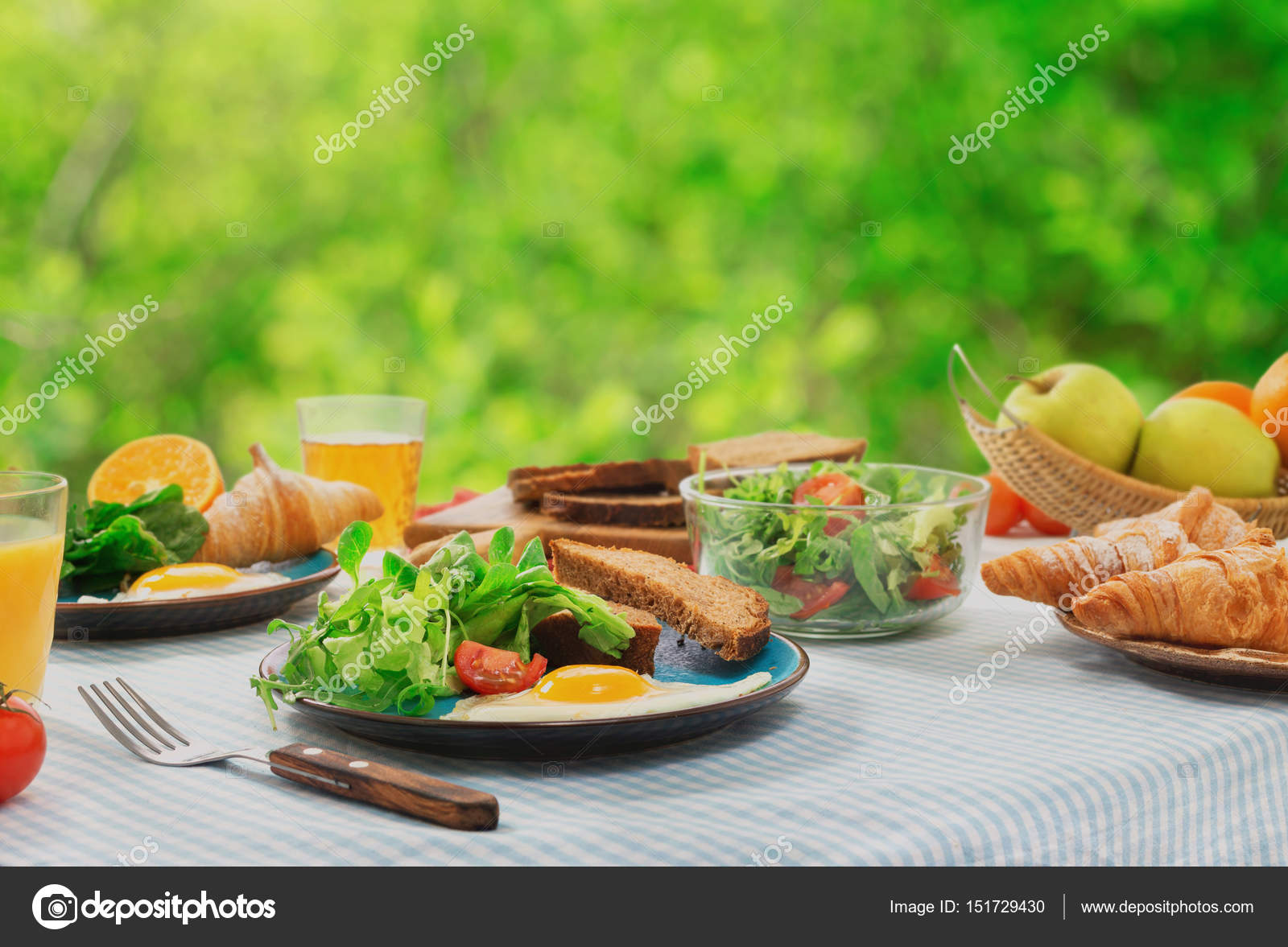 Breakfast table with healthy food. fried eggs, salad, croissants Stock ...