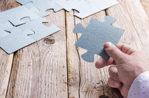 Incomplete puzzles lying on wooden rustic boards. - Stock Image ...