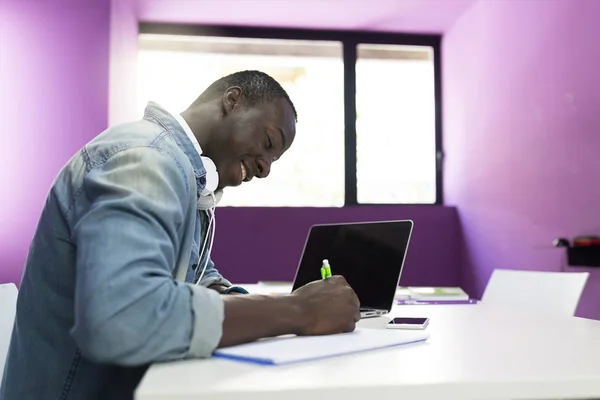 Handsome african man learning at classroom. - Stock Image - Everypixel