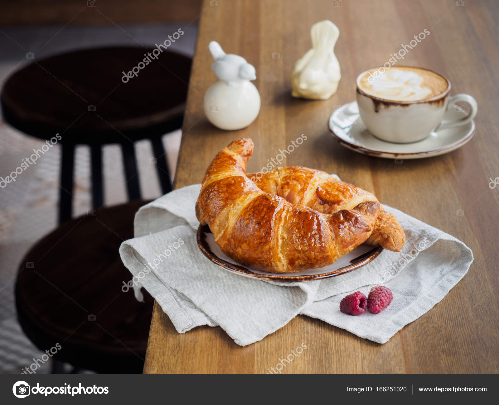 Two beautiful croissants in a plate on a wooden table Stock Photo by ...
