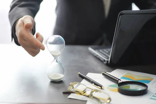 Working time symbolizes an hourglass. Office desk with insurance ...